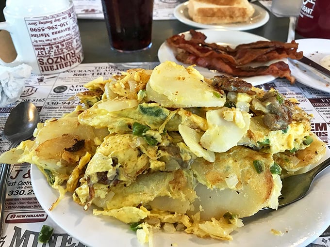 A mountain of eggs and potatoes that says, "You won't need lunch today." The bacon in the background is just showing off.