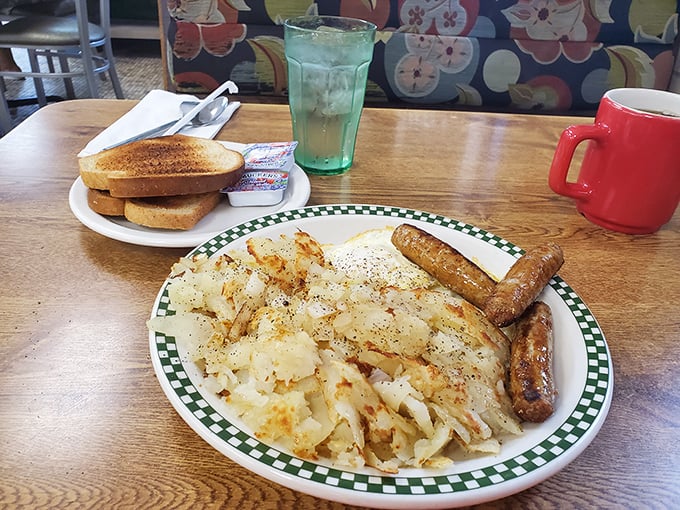 Home fries that achieve that mythical balance—crispy edges, tender centers—paired with sausage links that snap with each bite. Breakfast perfection exists.