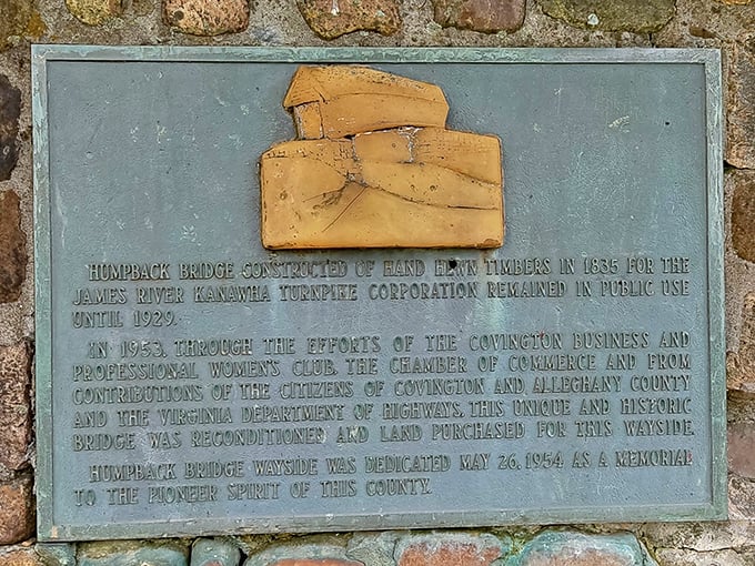 This weathered plaque reveals the bridge's origin story—like finding Batman's birth certificate tucked away in the Allegheny Mountains.