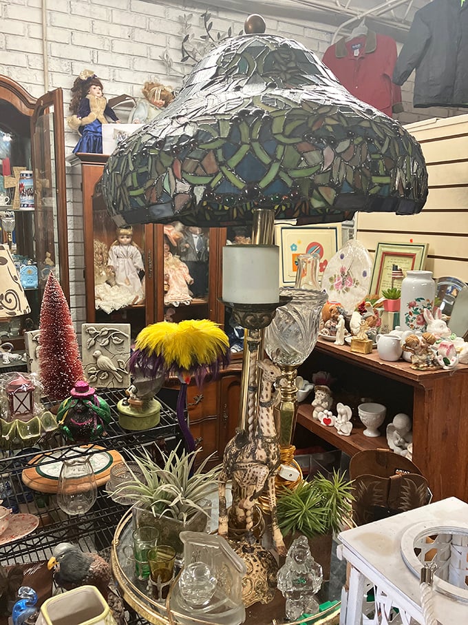 Not your average lighting department – this stained glass Tiffany-style lamp towers over porcelain figurines and vintage glassware in perfect antique harmony.