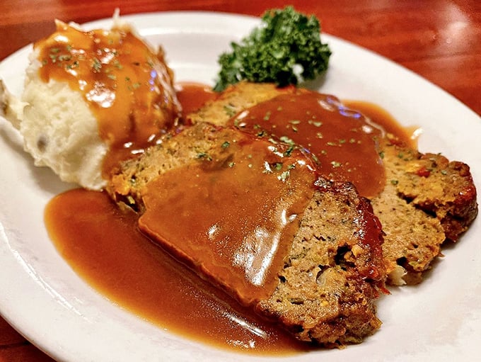 Meatloaf that would make your grandmother both jealous and proud. That gravy river flowing across the plate is pure comfort in liquid form.