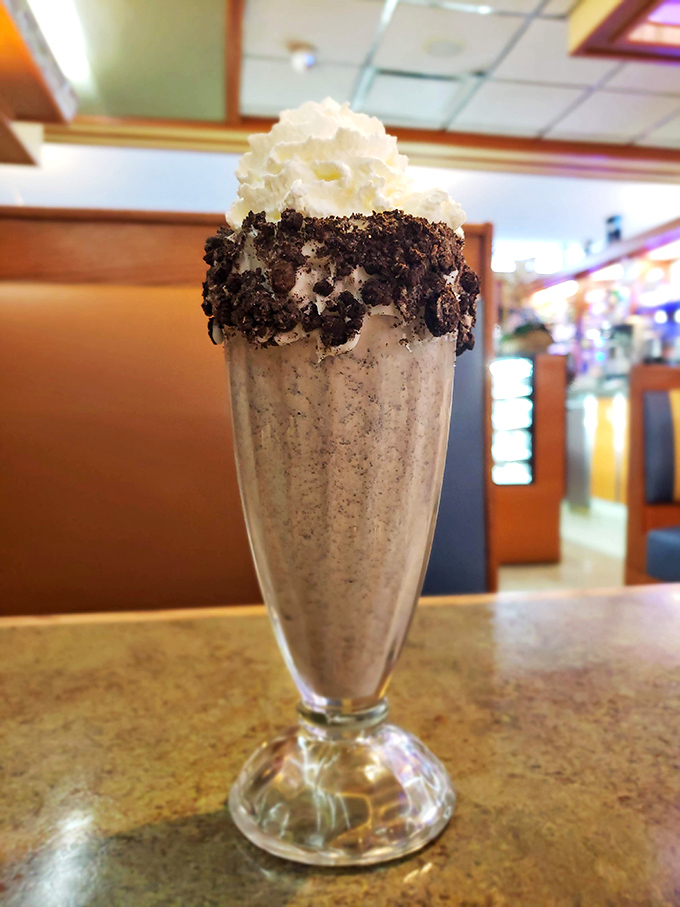 This isn't just a milkshake—it's dessert wearing a disguise. The Oreo rim is like a cookie necklace for your glass.