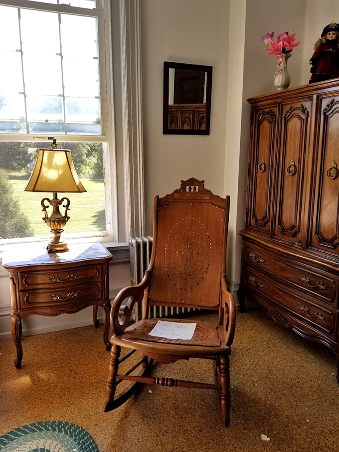 That antique rocking chair isn't moving on its own… is it? Period furnishings create an atmospheric glimpse into the building's past lives.