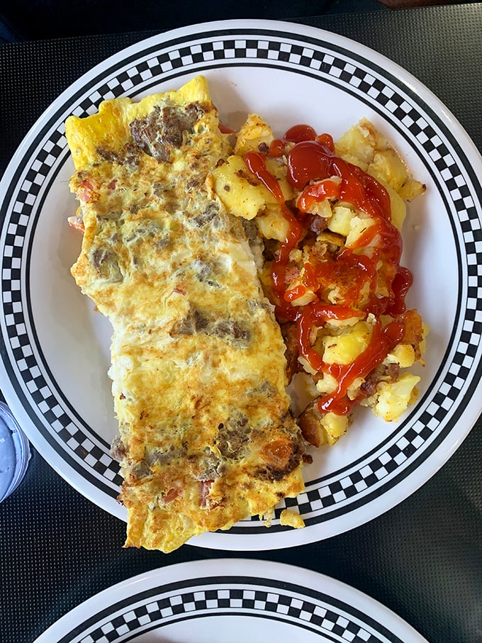 This isn't just an omelet—it's an architectural achievement of egg engineering, with enough fillings to qualify as apartment living for your fork.