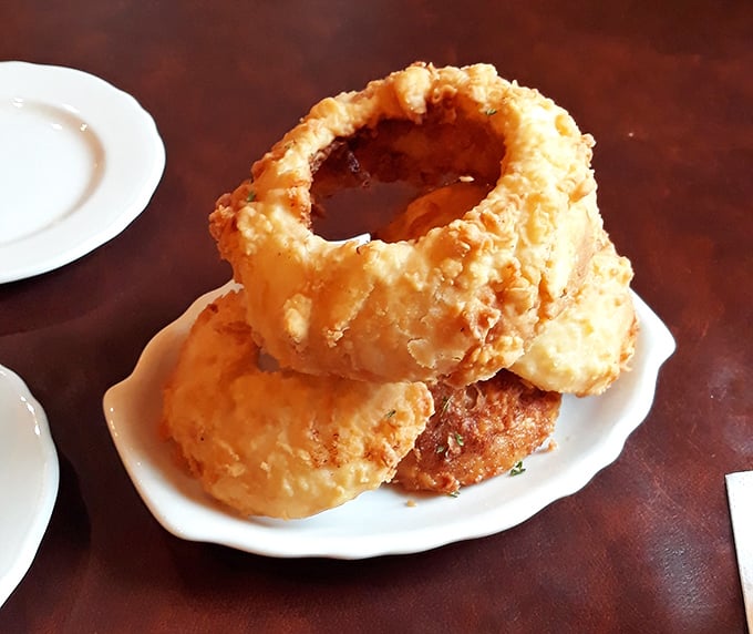 These aren't just onion rings—they're golden halos of happiness that shatter with a satisfying crunch before melting into sweet onion bliss. 