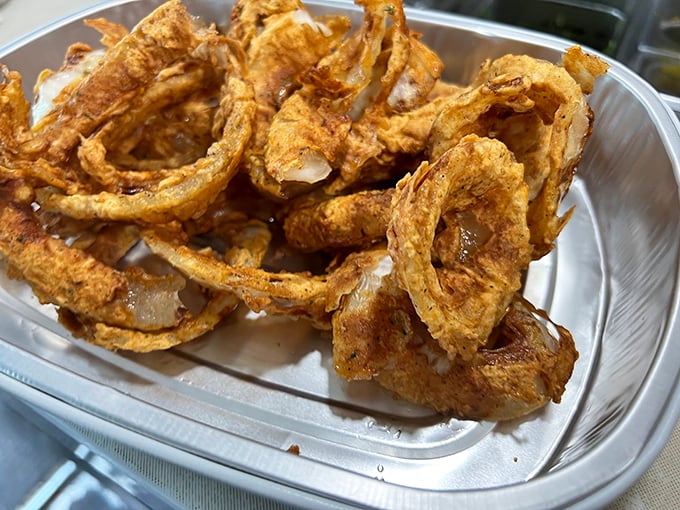 These onion rings aren't just side dishes – they're golden halos of happiness. The perfect crunch that makes you close your eyes and forget your troubles.