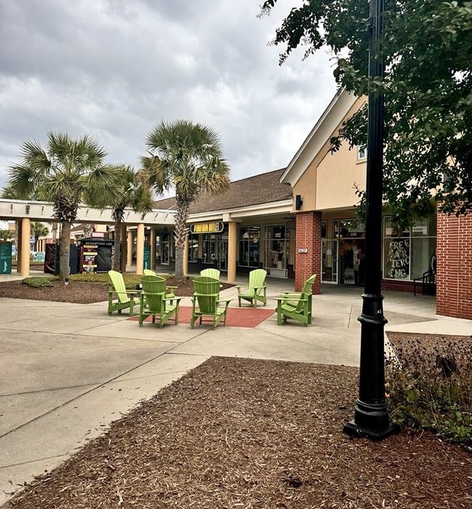 The lime green Adirondack chairs beckon weary shoppers like oases in a desert of deals—perfect for that mid-shopping ice cream break.