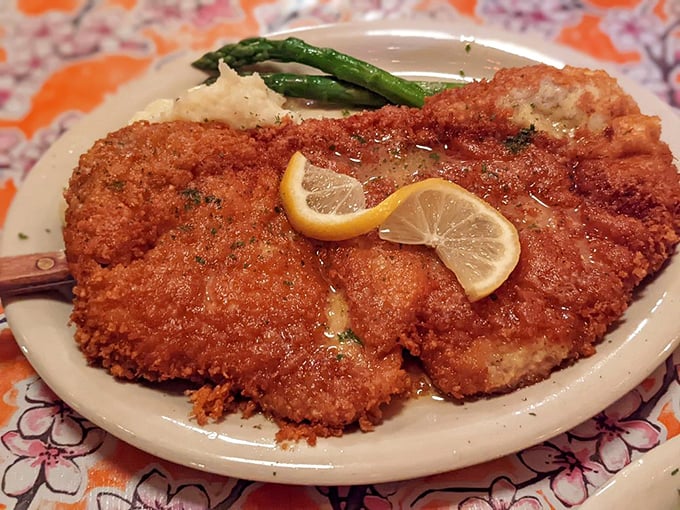 The Perkinsville Pork arrives golden and crisp, with lemon slices that aren't just garnish but essential supporting actors in this culinary performance.