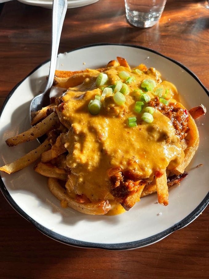 The legendary poutine that launched a thousand road trips—hand-cut fries swimming in rich gravy with cheese curds playing hide and seek throughout.