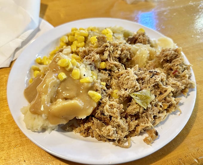 Comfort on a plate: pulled pork nestled beside mashed potatoes and corn, all swimming in gravy that could solve most of life's problems.