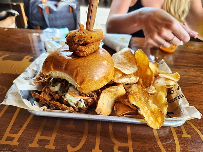 A sandwich that requires engineering skills to eat—stacked high with pulled pork and onion rings, it's a beautiful mess worth making.