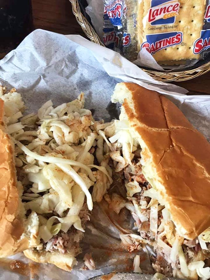 The pulled pork sandwich in its natural habitat—simple, unpretentious, and absolutely perfect with that fresh slaw adding just the right crunch.