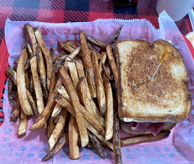 A proper grilled sandwich with golden-brown bread and a mountain of hand-cut fries – comfort food that speaks the universal language of "mmmmm."