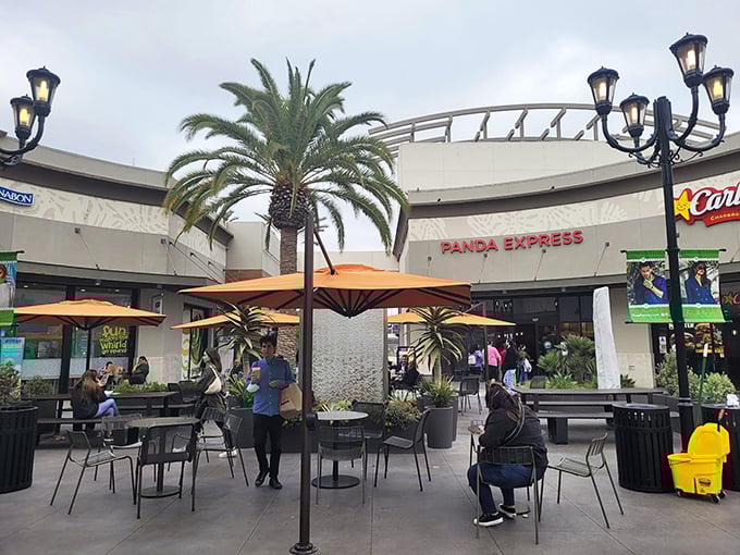 The food court's outdoor seating area – where shoppers recharge with Panda Express while plotting their next retail conquest.