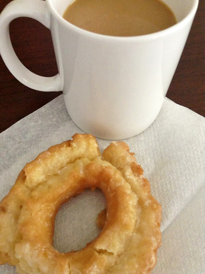 The humble sour cream donut alongside coffee—America's power couple that never needs couples therapy. Simple perfection.