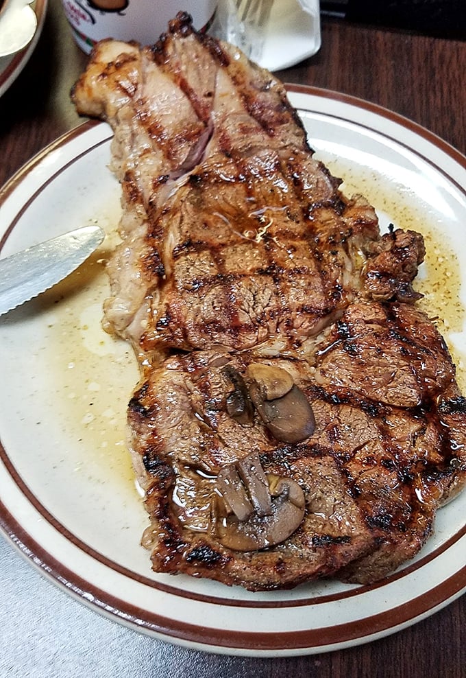 A steak that's been kissed by flame and seasoned with expertise—simple perfection on a no-nonsense plate.