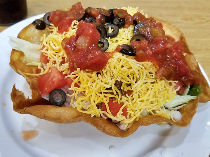 A taco salad that defies gravity and good sense – a crispy tortilla bowl filled with enough toppings to feed a small family.