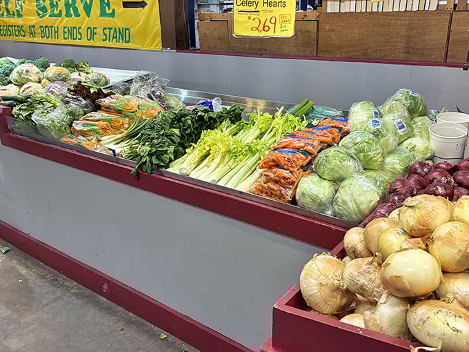 Fresh produce arranged with military precision—where celery hearts, cabbage, and onions stand at attention, awaiting your culinary commands.