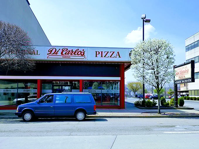 Classic red and white storefront design that's been welcoming pizza lovers for generations of satisfied customers.