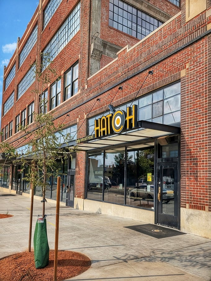 Hatch's bold signage pops against historic brick—a modern breakfast statement in Oklahoma City's urban landscape.