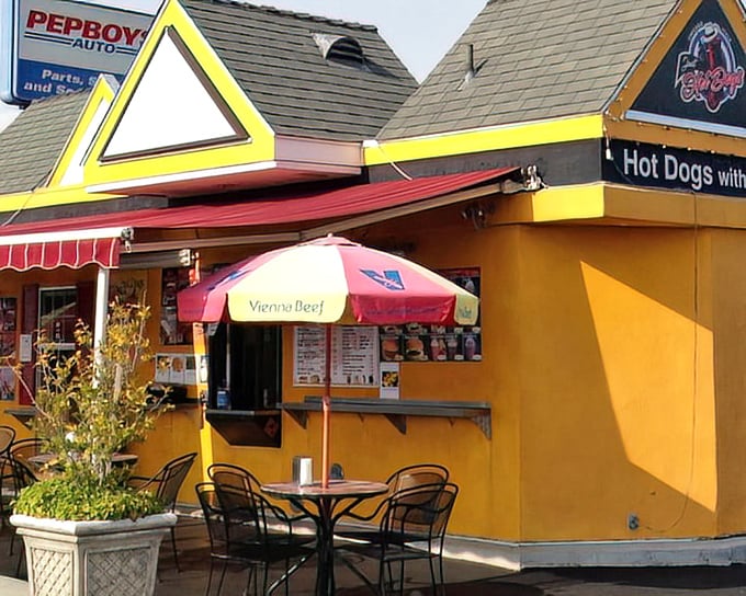 That distinctive peaked roof and sunny yellow paint job screams "authentic Chicago dogs served with California sunshine."