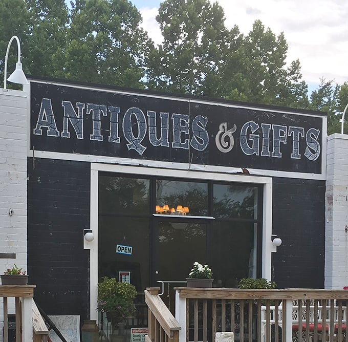 "Antiques & Gifts" – a simple black and white promise of treasures waiting behind this unassuming storefront.