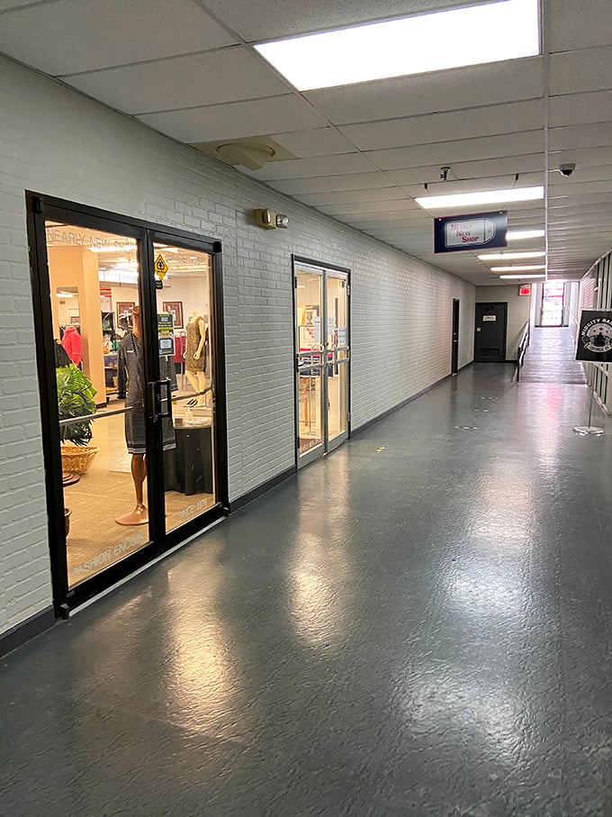 Nearly New Shop's corridor feels like the backstage pass to bargain heaven. Those glass doors reveal glimpses of treasures waiting to be discovered.