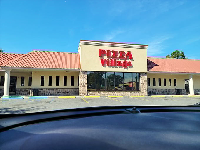 Pizza Village's bold red sign has been a Lafayette landmark for generations, calling families home to their booth like clockwork.