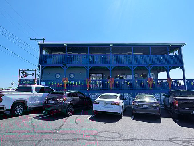 Ray's blue exterior and weathered deck – where that giant blue lobster statue isn't just decoration, it's a promise.