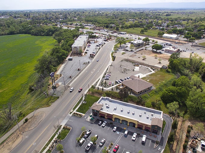 Red Bluff's emerald fields embrace commercial outposts along the highway—where agriculture and commerce perform their daily handshake.