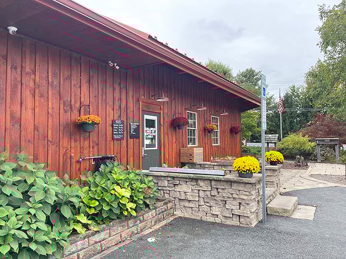 Stampede's cozy cabin exterior with hanging flower baskets feels like visiting your favorite aunt—if she happened to be a barbecue genius.