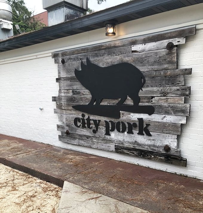 Those red roses framing the rustic sign create the perfect contrast – much like how their sauce complements their perfectly smoked meats.