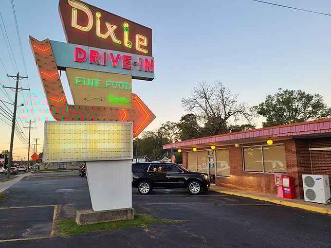 That neon arrow isn't just pointing to a restaurant—it's guiding you toward milkshake nirvana and onion ring bliss.