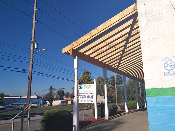 The wooden pergola entrance at Mountain Mission offers a moment of shade before you dive into a world of thrifty treasures.