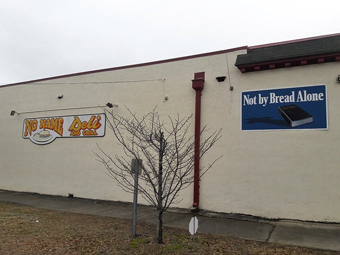 The "Not by Bread Alone" sign tells you everything – these folks take sandwich philosophy seriously.