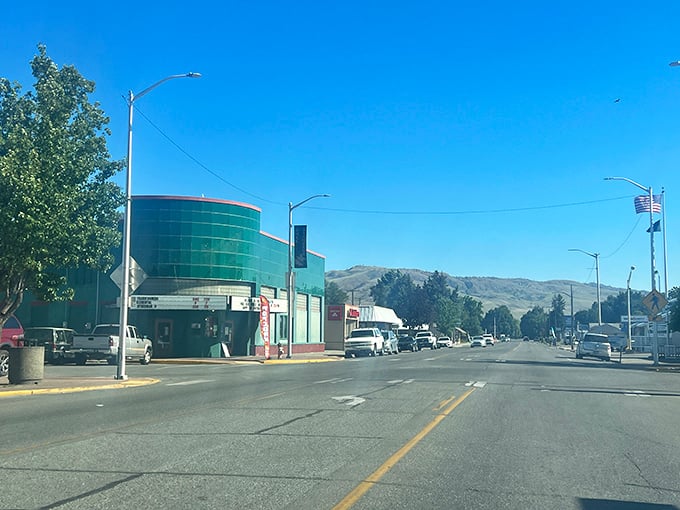 That minty-green art deco facade in Omak whispers tales of Saturday matinees and first kisses—when popcorn cost a nickel and smartphones were science fiction.