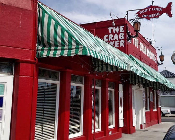 The Crab Cooker's whimsical fish sign warns "Don't Look Up Here" while the real attention-grabber waits inside your bowl.