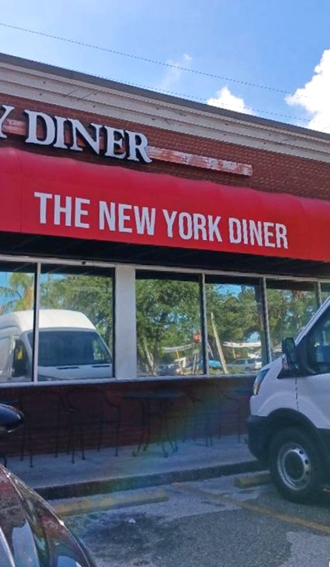 The red awning beckons like a beacon for anyone seeking real deli satisfaction in unexpected places.