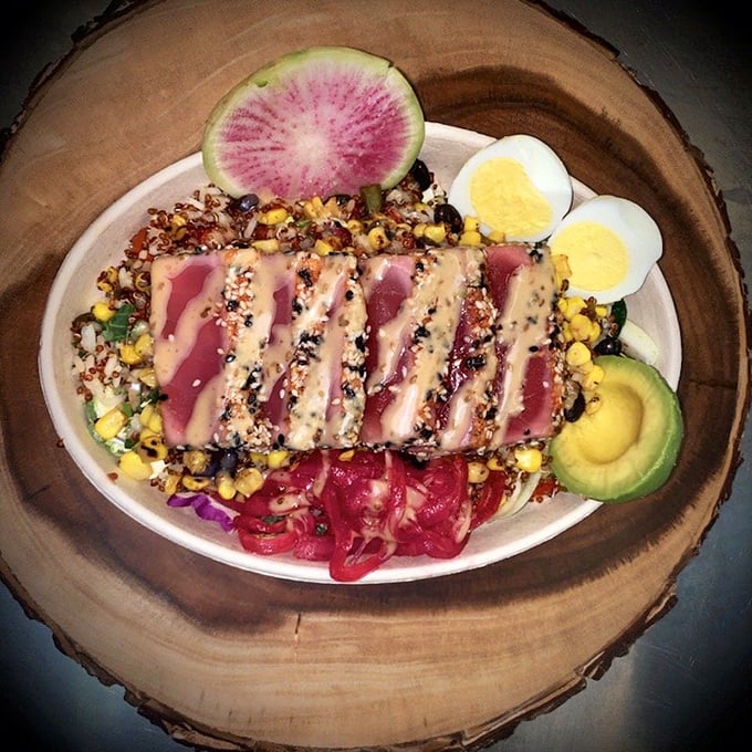 Seared ahi tuna, pink as a sunset, resting on a vibrant bed of grains and vegetables—proof that Jolly Rogers isn't just about the fryer.