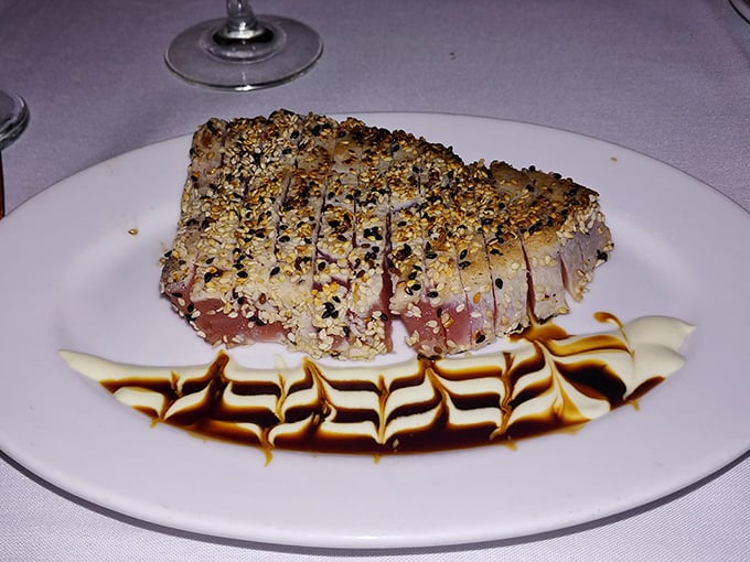Sesame-crusted tuna with artistic sauce work that makes you pause before diving in—but only for a second, because willpower has its limits.