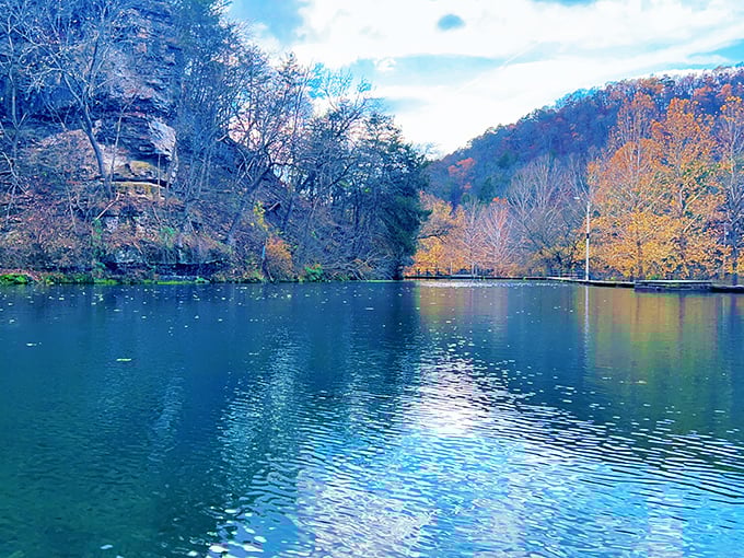 Fall's masterpiece reflected in turquoise waters – autumn colors frame the impossibly blue spring waters like nature's own Instagram filter.