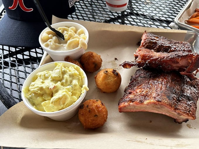 Ribs, mac and cheese, potato salad, and hush puppies – the Mount Rushmore of Southern BBQ, carved with smoke and patience.