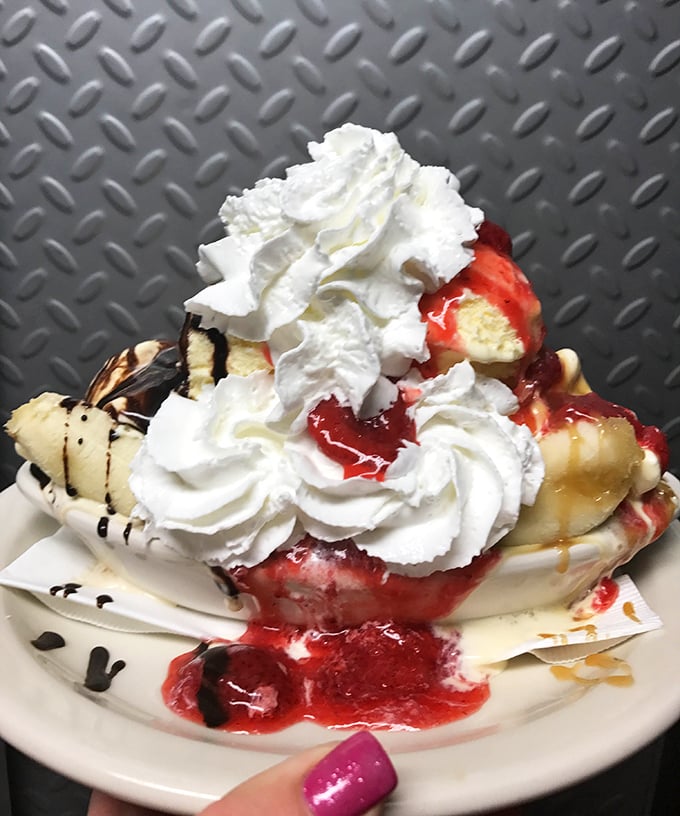 This isn't just dessert—it's a structural engineering marvel of whipped cream, strawberries, and ice cream that would make your dentist weep and your inner child rejoice.