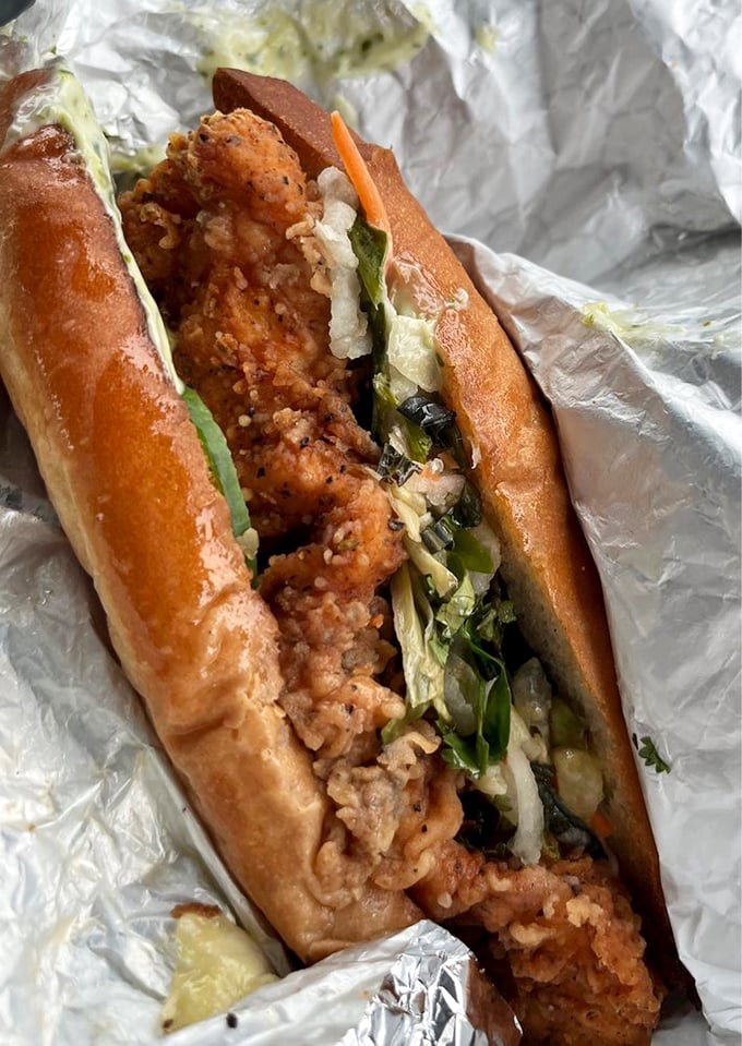 The Banh Mi sandwich—where crispy chicken meets fresh veggies in perfect harmony. Cultural fusion that makes your taste buds sing karaoke.