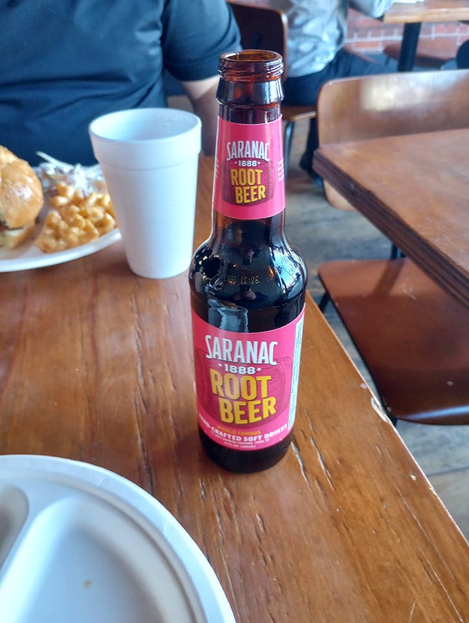 Even the beverages keep it real. A craft root beer stands ready to cut through the richness of smoked meats without stealing the spotlight.