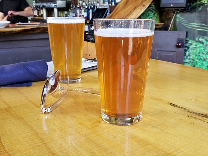 Two beers catching the light like liquid amber jewels—proof that sometimes the simplest pleasures are worth pausing your day for.