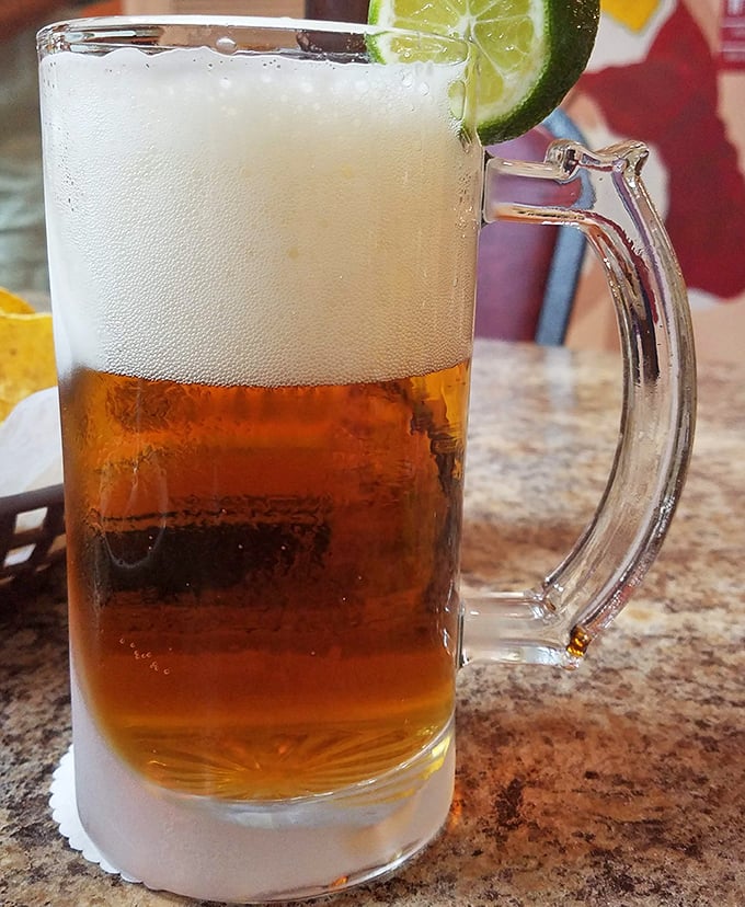 A frosty mug of cerveza with lime – because sometimes the perfect pairing for spicy Mexican food is simply cold, crisp beer. The condensation tells you it's ready.