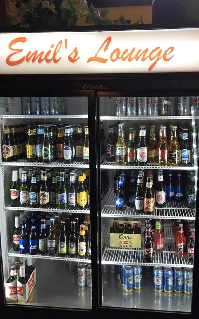 The beer cooler at Emil's offers a democratic selection—from craft options to reliable classics, all equally welcome at this unpretentious establishment.