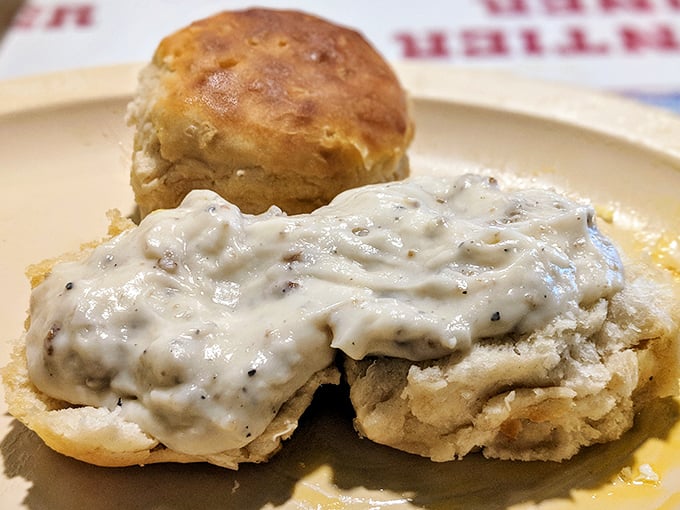These biscuits and gravy aren't just food—they're an edible history lesson in Southern comfort, with pepper specks telling stories in every bite.