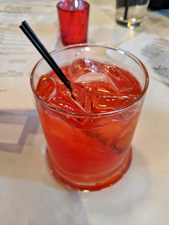A ruby-red cocktail that promises refreshment with a kick—the perfect companion while deciding between all those seafood options.